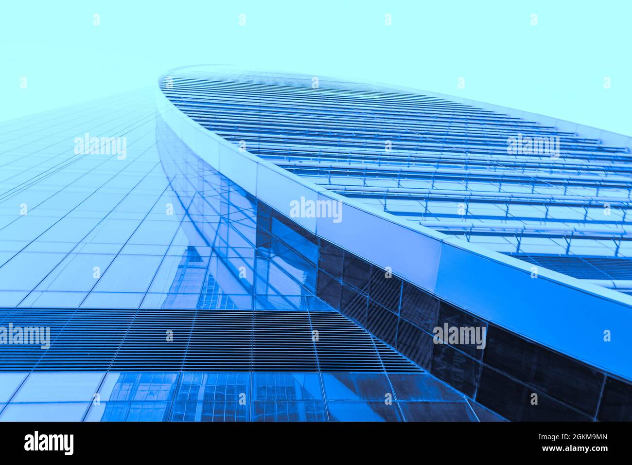 Perspective wide angle view to steel light blue glass surface, building ...