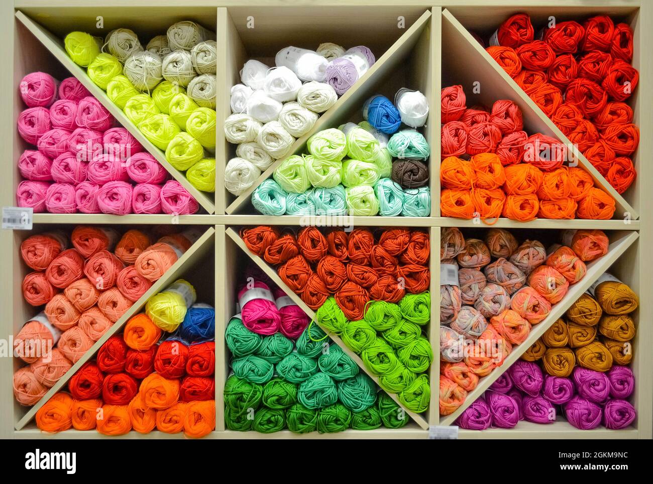 Shelf with colorful colors wool yarn balls on shop display stand for ...
