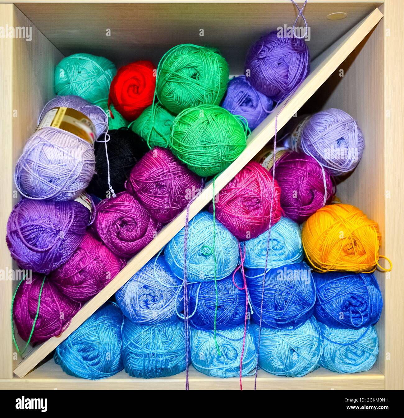 Shelf with colorful colors wool yarn balls on shop display stand for ...