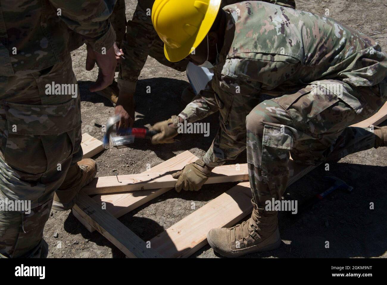 U.S. Army Soldiers create a frame that will be used in the laying of ...