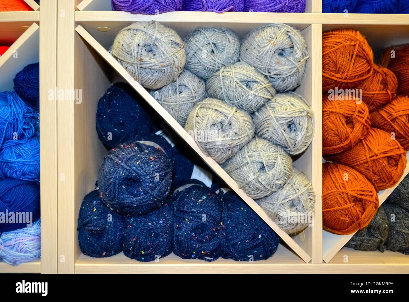 Shelf with colorful colors wool yarn balls on shop display stand for ...