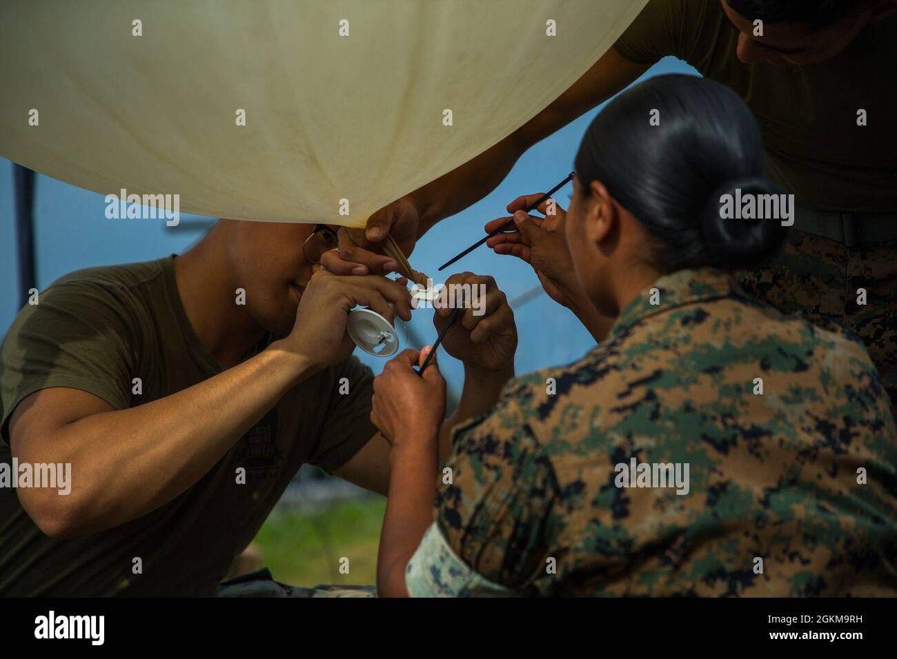 U.S. Marine Corps Cpl. Alicia Lucio, right, Cpl. Tim Roberts, center ...