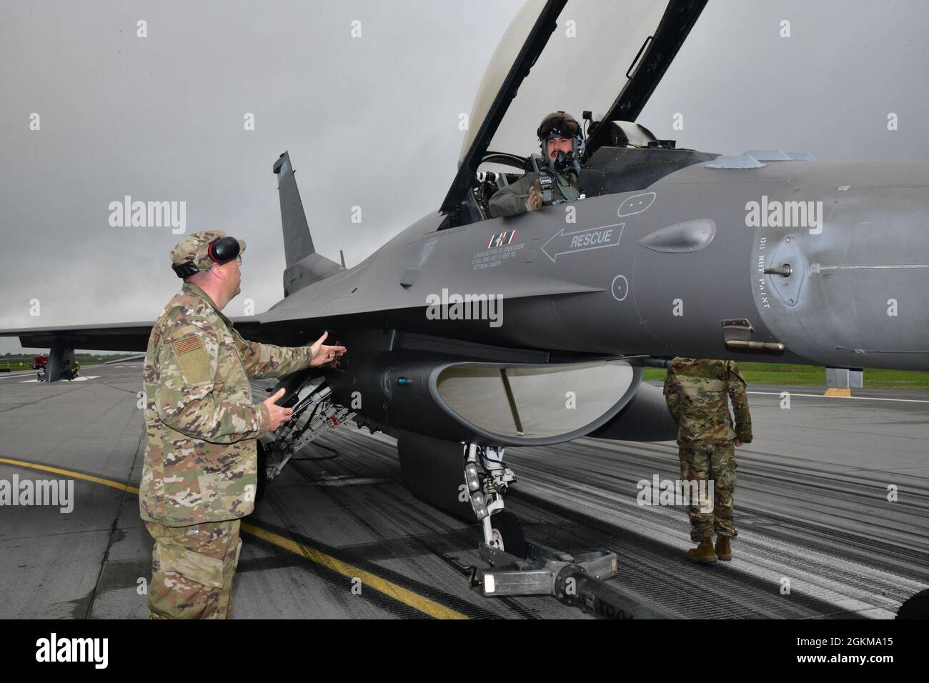 A Power Production Specialist debriefs with an F-16 pilot after an ...