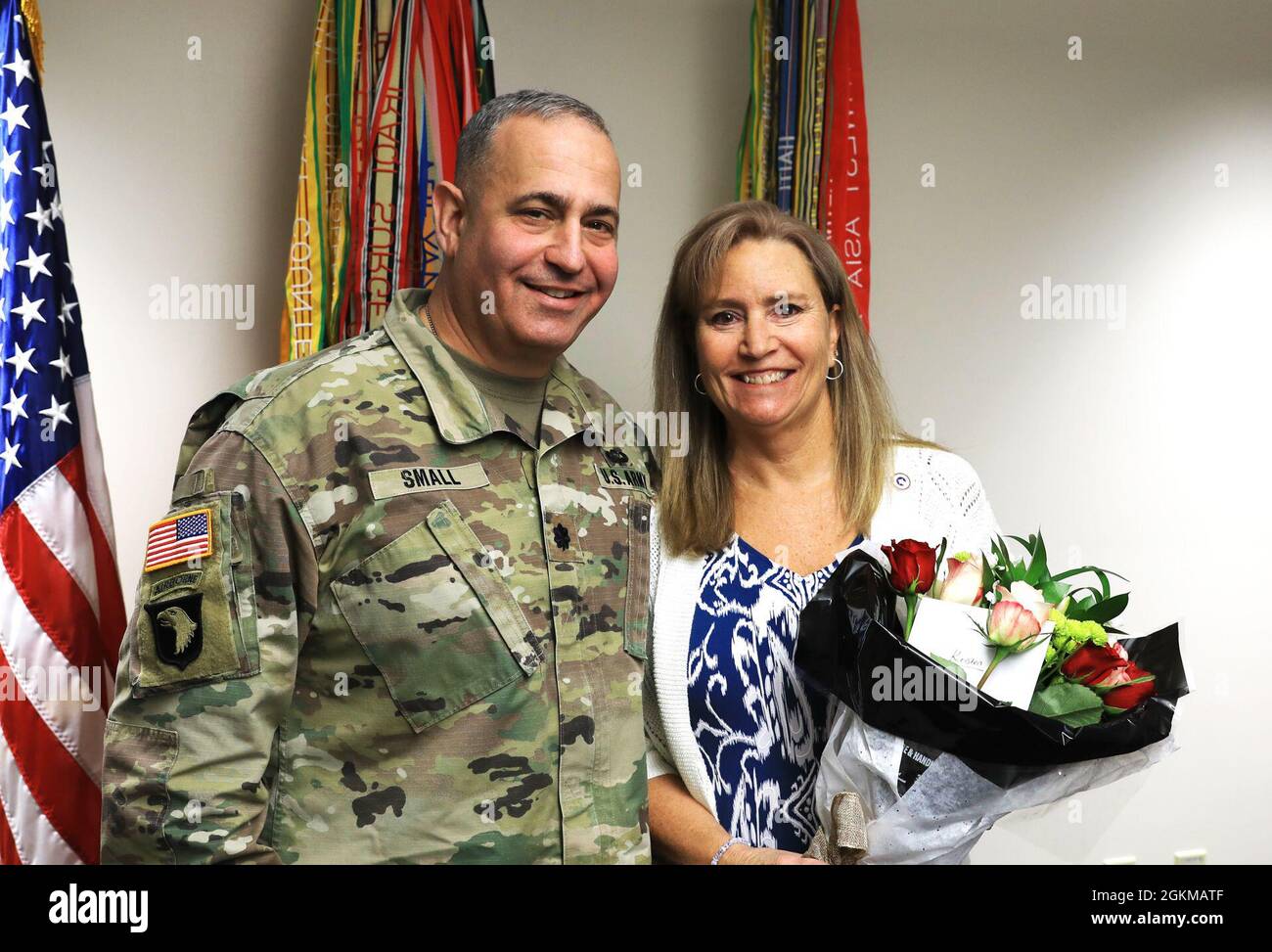 Mrs. Kristen Small stands with her husband Lt. Col. Michael Small after ...