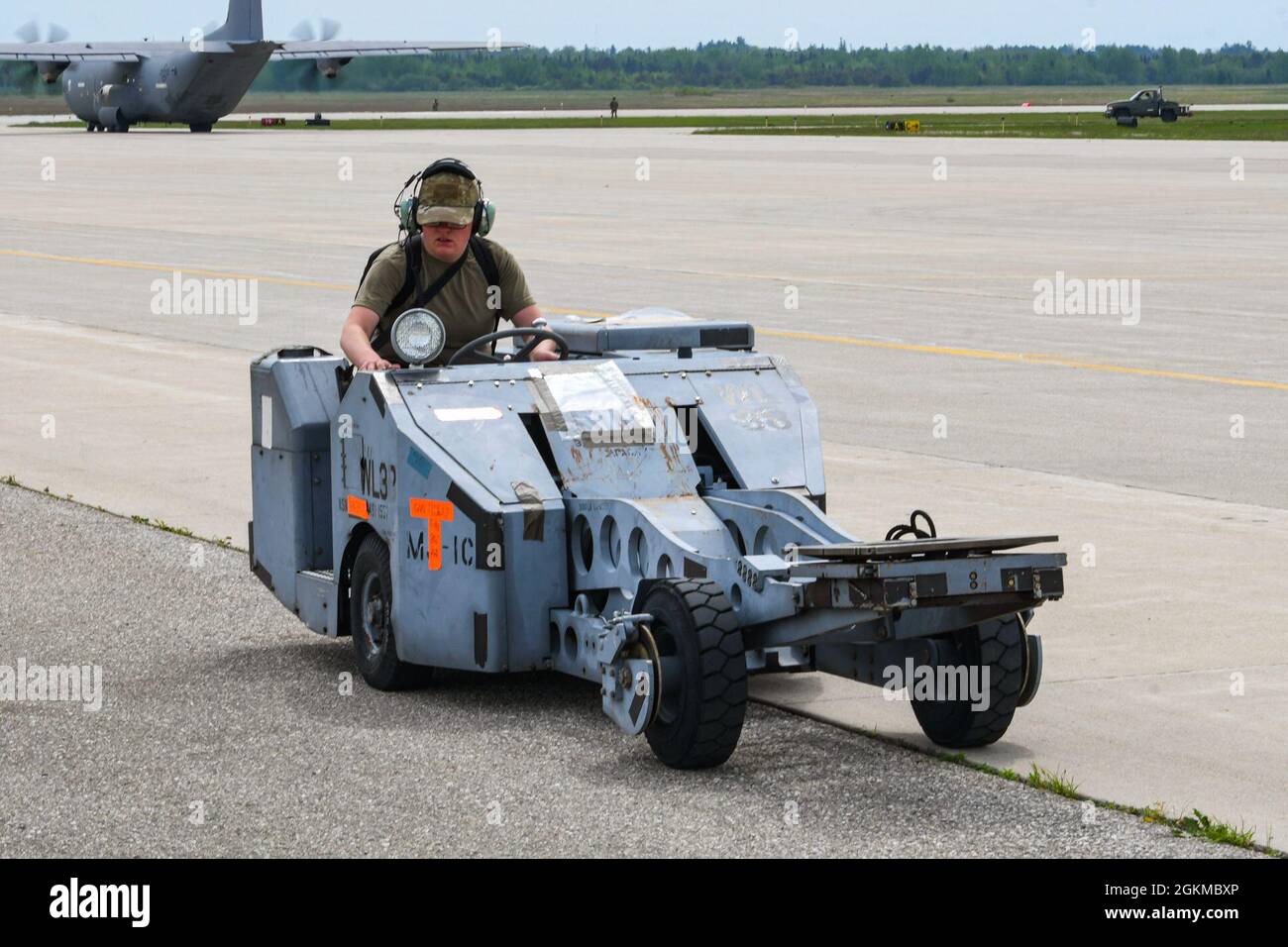 An Airman from the 354th Aircraft Maintenance Unit drives a MHU-83 Bomb ...