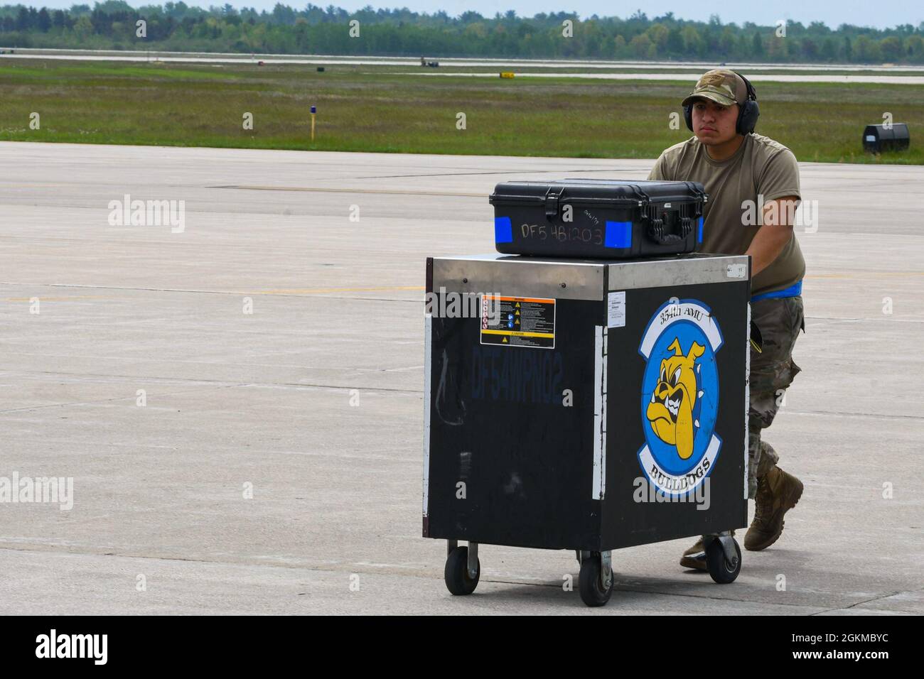 An Airman from the 354th Aircraft Maintenance Unit rolls a tool box on ...