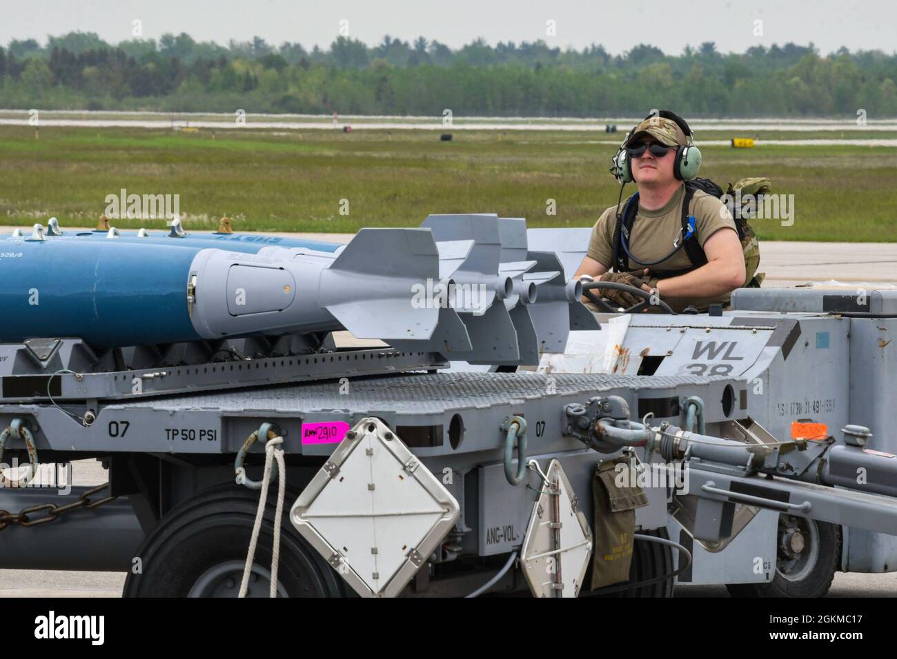 An Airman from the 354th Aircraft Maintenance Unit drives a MHU-83 Bomb ...