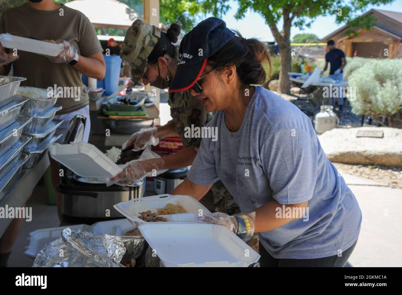 Team Kirtland members prepare lunch boxes for guests at the Asian ...