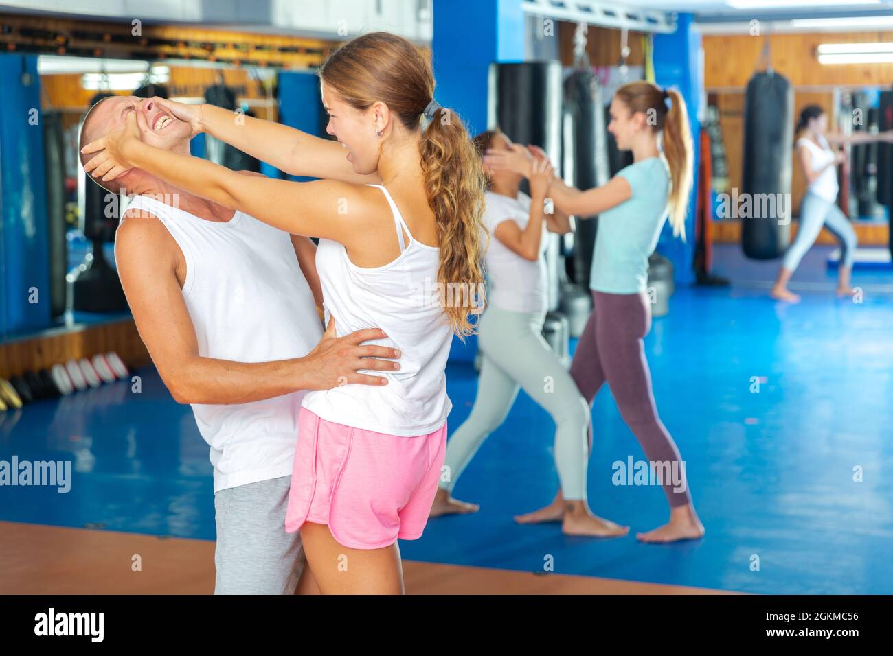 Young woman practicing self defence techniques with coach Stock Photo ...