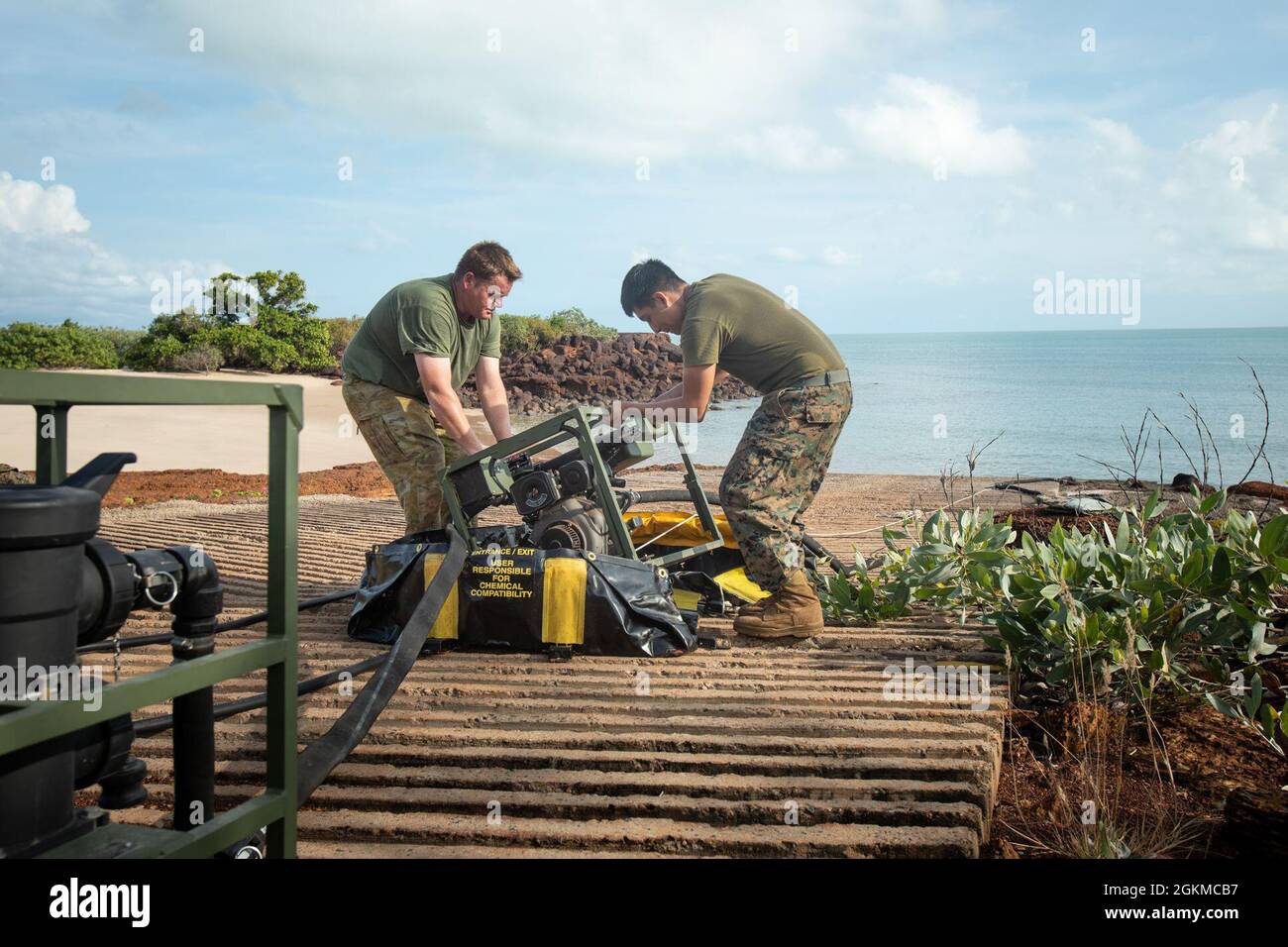 U.S. Marine Corps Lance Cpl. Jerry GarciaVillegas, right, a water ...