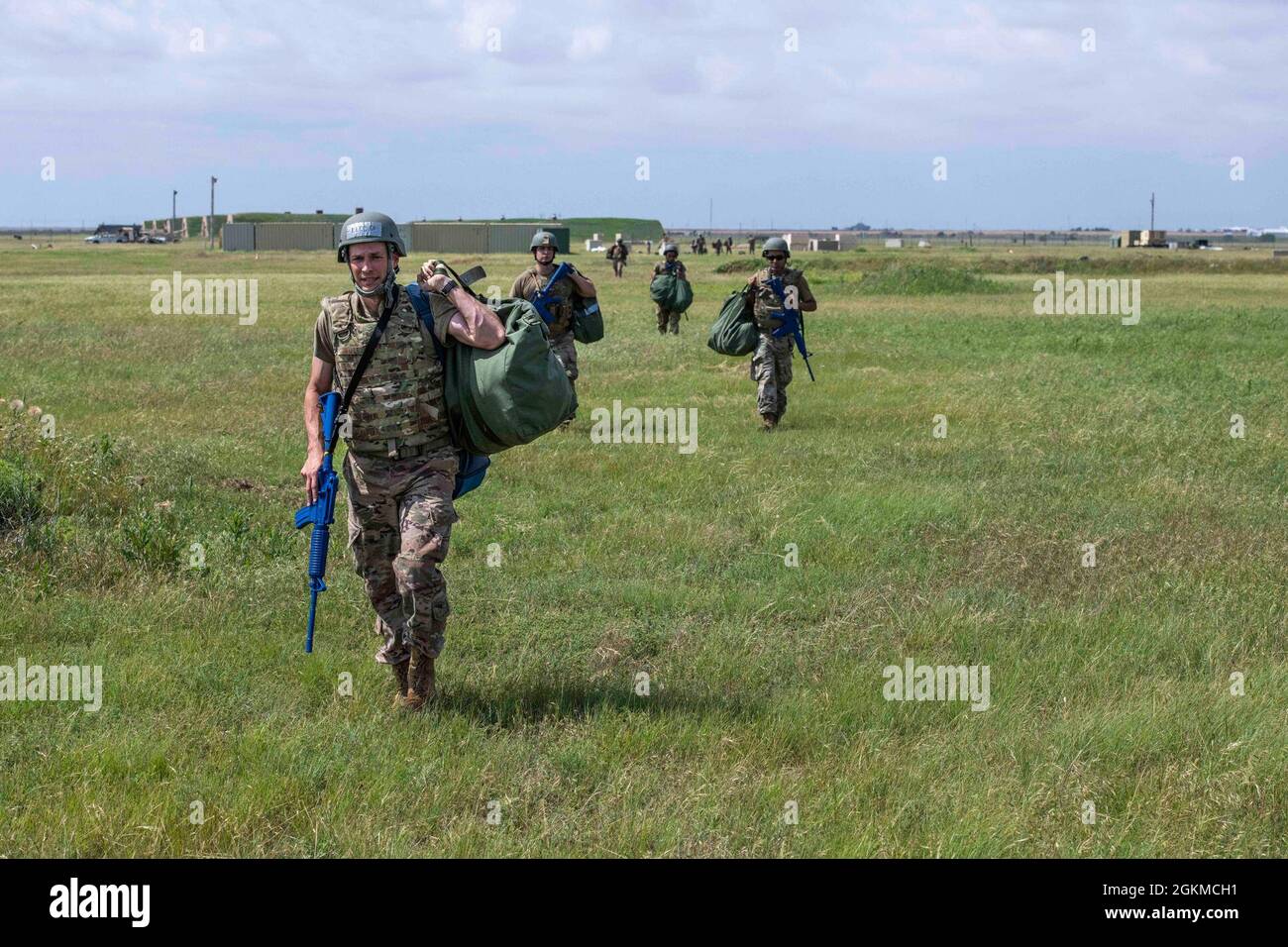 U.S. Air Force Airmen of the 97th Civil Engineer Squadron (CES) walk ...