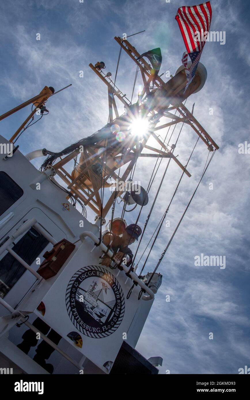 Coast Guard Seaman Rafael Santiago Castro posts the National Ensign on ...