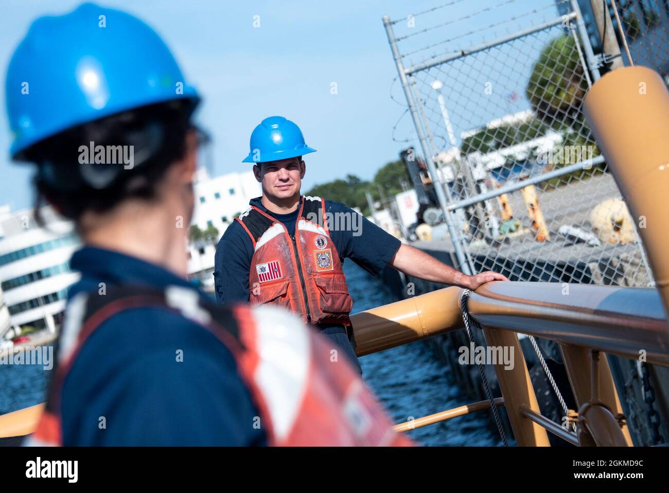 Coast Guard crew members on the USCGC Brant handle lines and prepare to ...