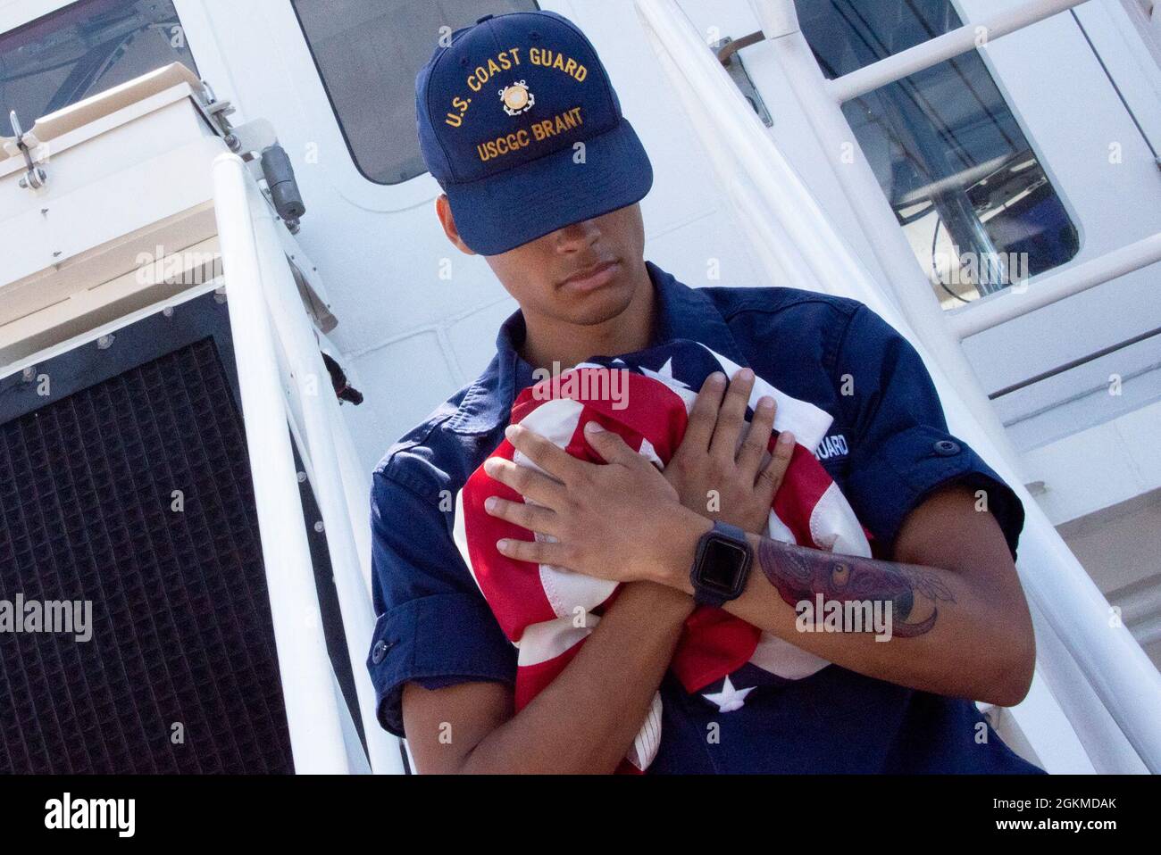 Coast Guard Seaman Rafael Santiago Castro posts the National Ensign on ...