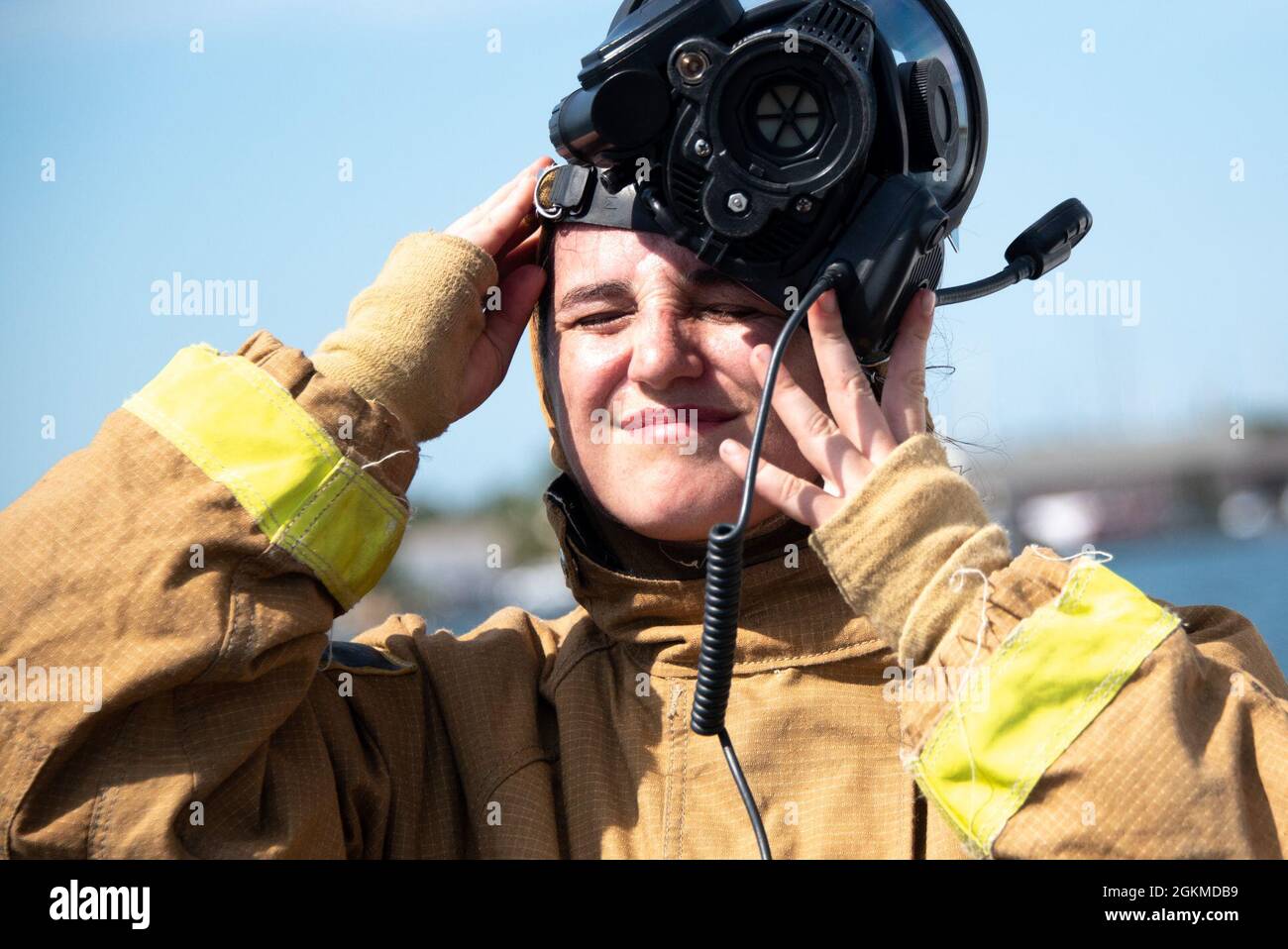 Coast Guard Seaman Alexa Criste removes her fire fighting gear, after ...