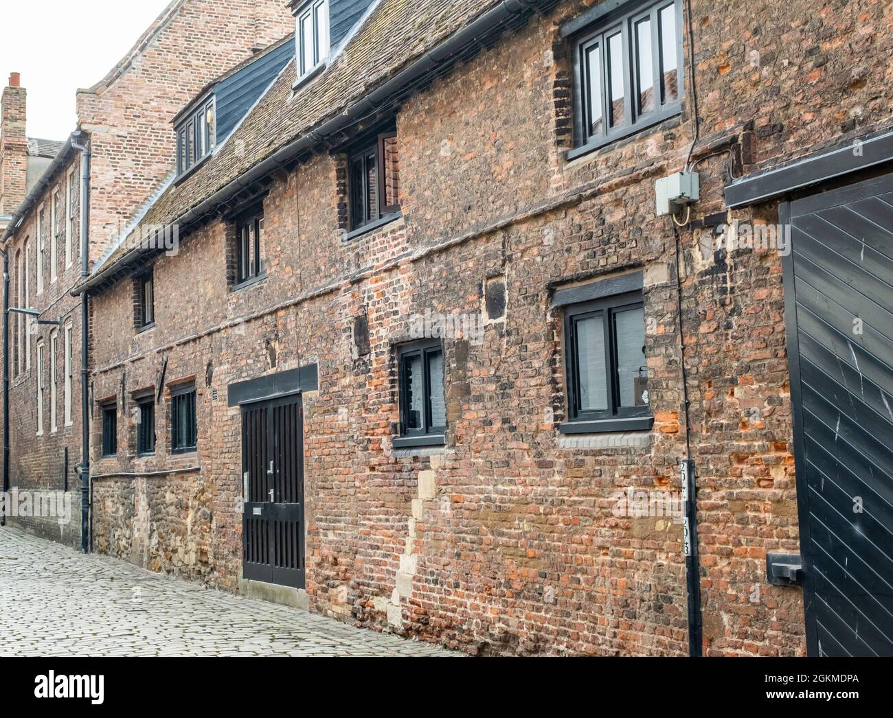 Historic brick building on cobbled street in King's Lynn Stock Photo ...