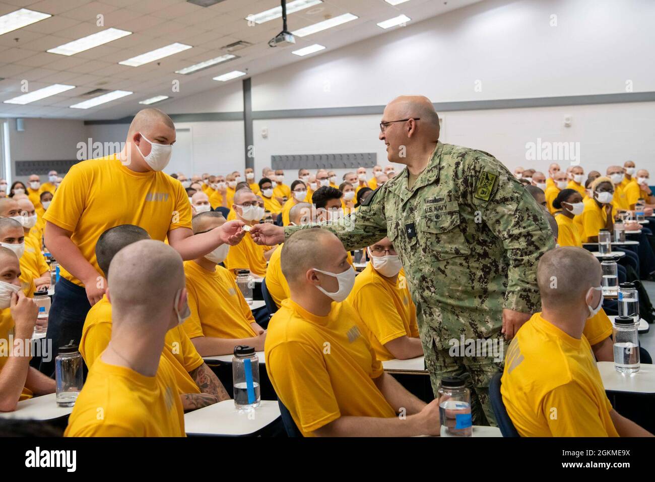 Rear Adm. Dennis Velez, commander, Navy Recruiting Command, presents a ...
