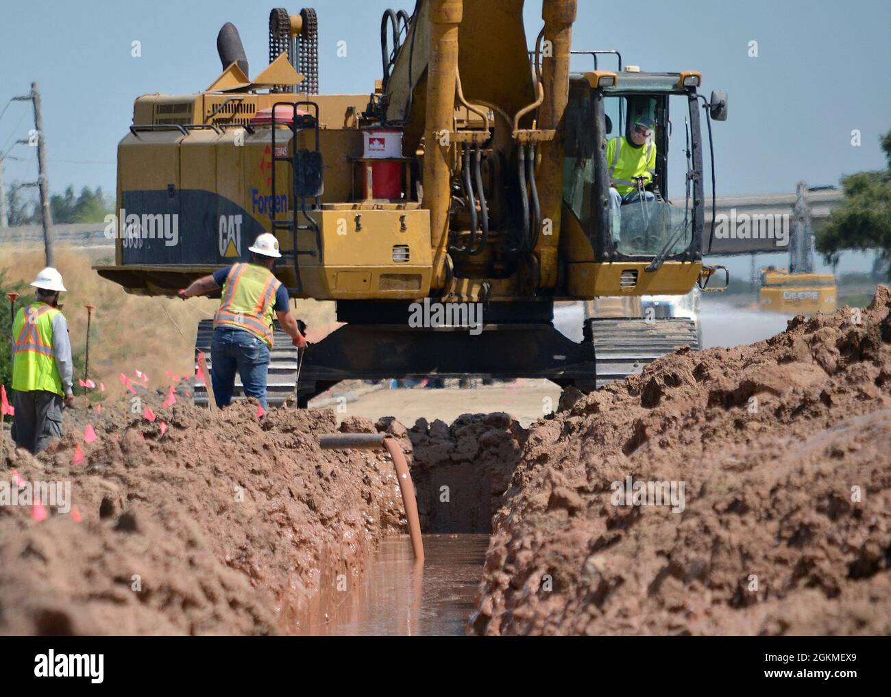 The excavator operator pauses work in order to allow another ...