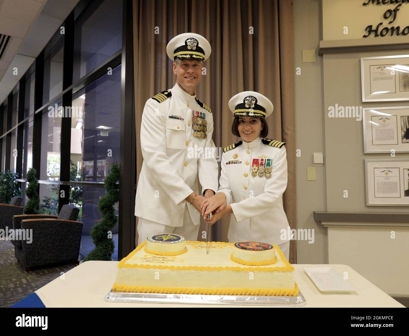 Capt. Devin Morrison and Capt. Kimberly Davis cut a cake to celebrate ...