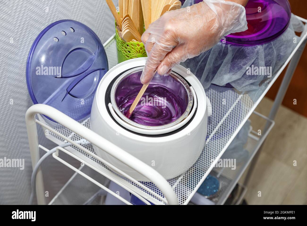 Image of melted purple wax on wooden stick for depilation Stock Photo ...