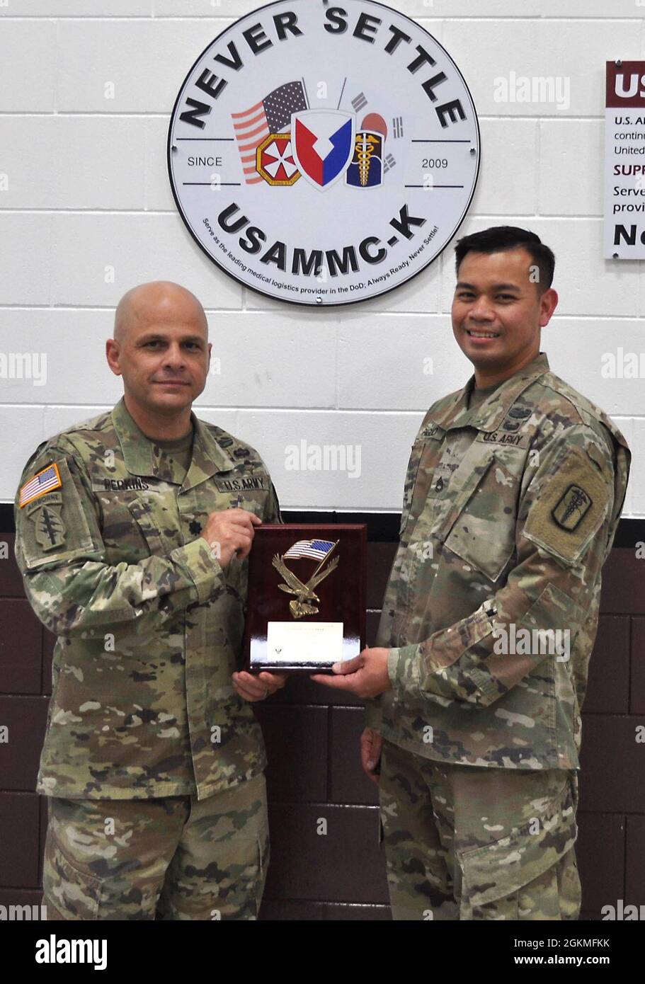 Sgt. 1st Class Rizmel Paguio, right, poses with Lt. Col. Marcus D ...
