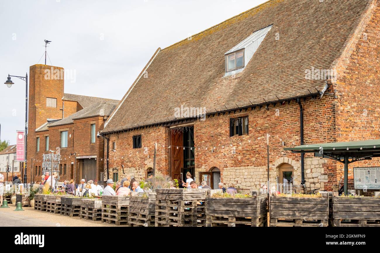 Drinkers and diners enjoying refreshments sat on the outdoor seating of ...