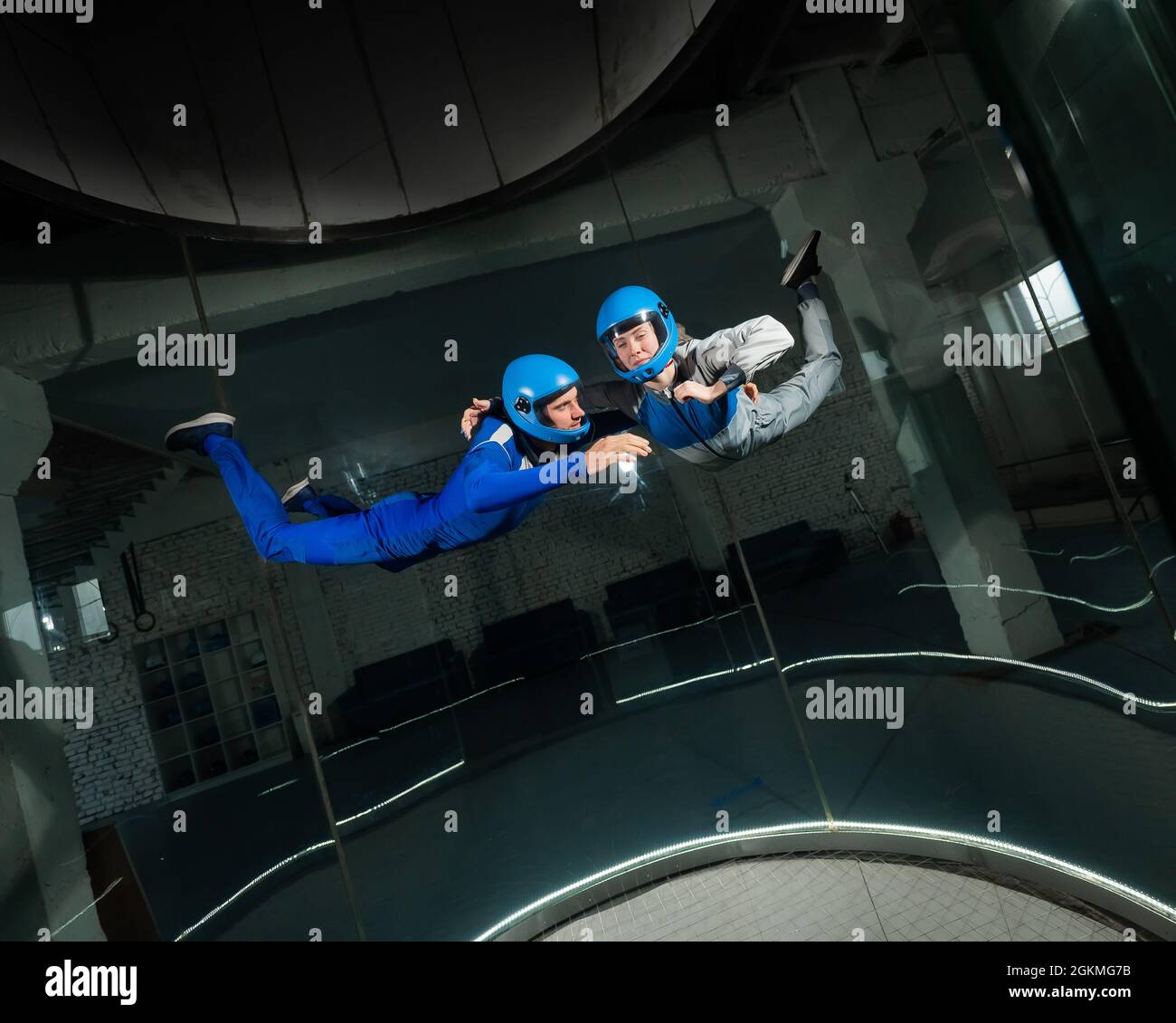 A man and a woman enjoy flying together in a wind tunnel. Free fall ...