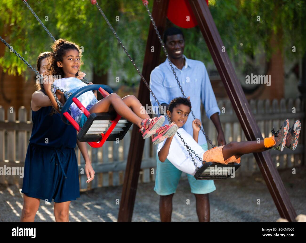 Family having fun on swing Stock Photo - Alamy