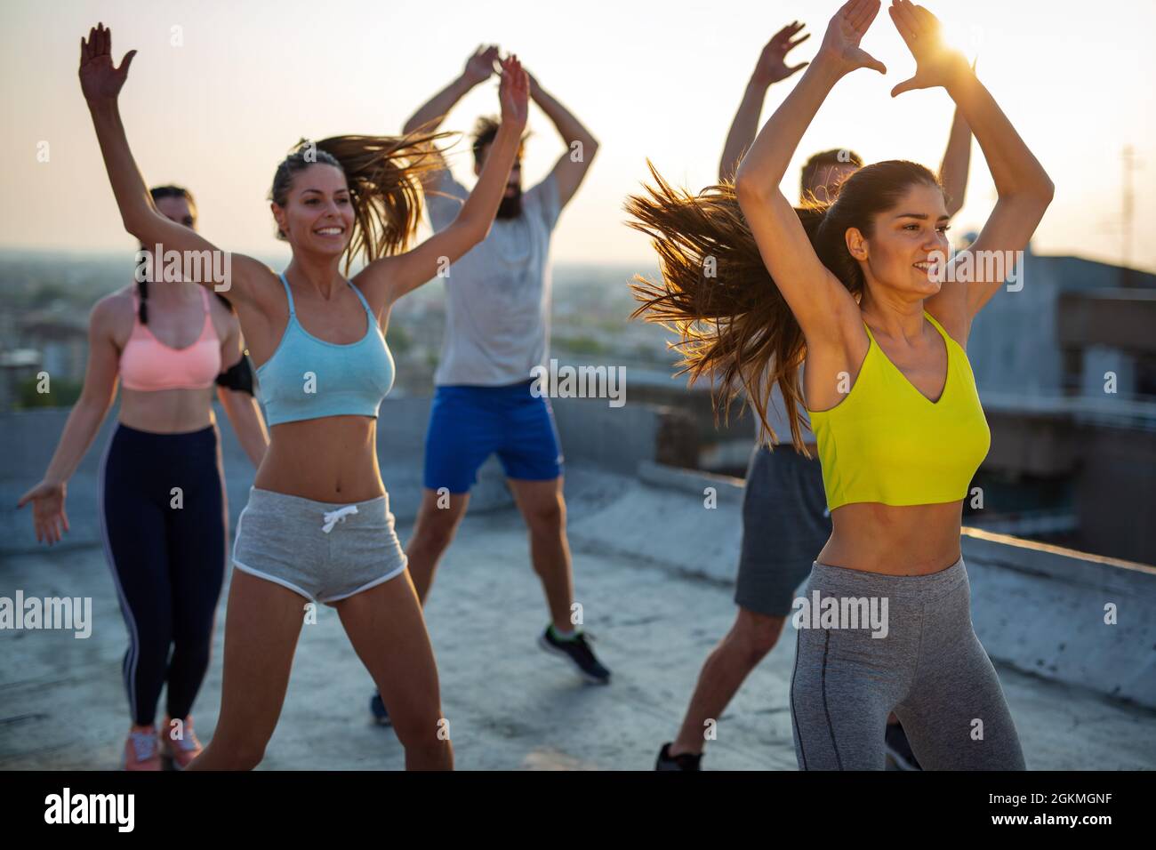 Group of happy fit friends exercising together outdoor Stock Photo - Alamy
