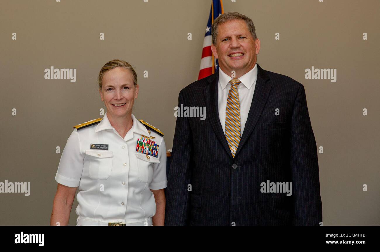 Rear Admiral Sara Joyner (left), Assistant Secretary of the Navy James Geurts (right) stand ...