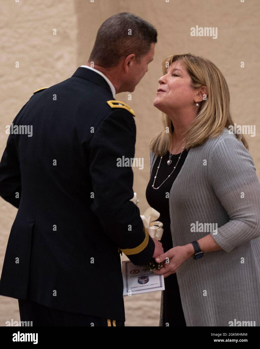 Maj. Gen. Daniel Mitchell kisses his wife, Lori, after presenting her ...