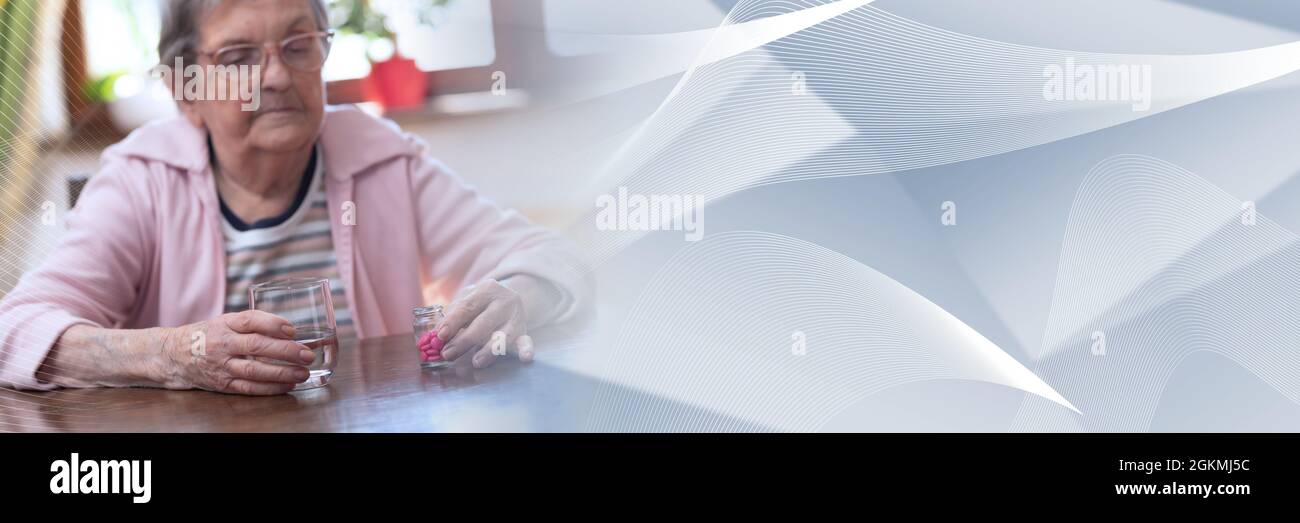 Elderly woman taking her medicine at home; panoramic banner Stock Photo ...