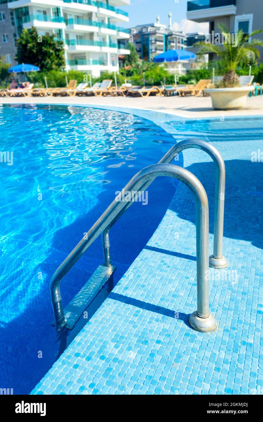 Swimmimg pool with stairs at hotel. Pool railing closeup Stock Photo ...