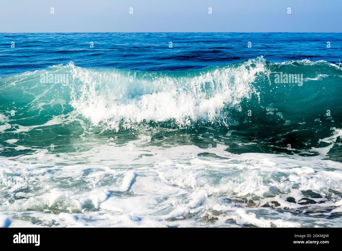 Sea waves breaking on a stony beach, forming sprays and splashes Stock ...