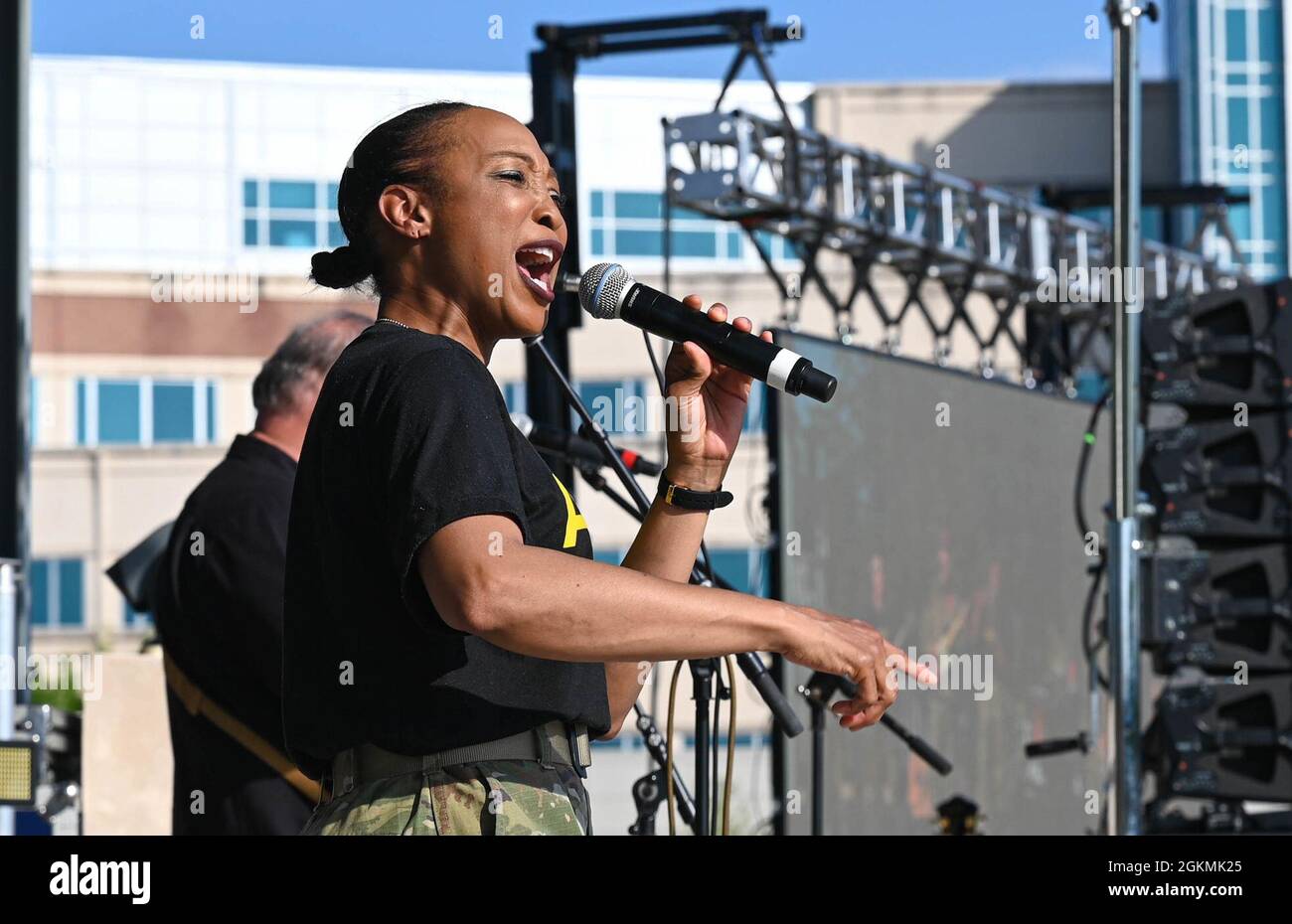 A member of the U.S. Army Training and Doctrine Command Band, sings ...