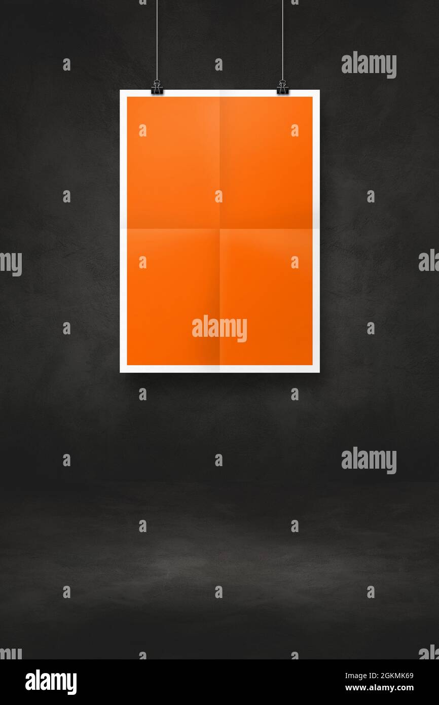 orange folded poster hanging on a black wall with clips. Blank mockup ...