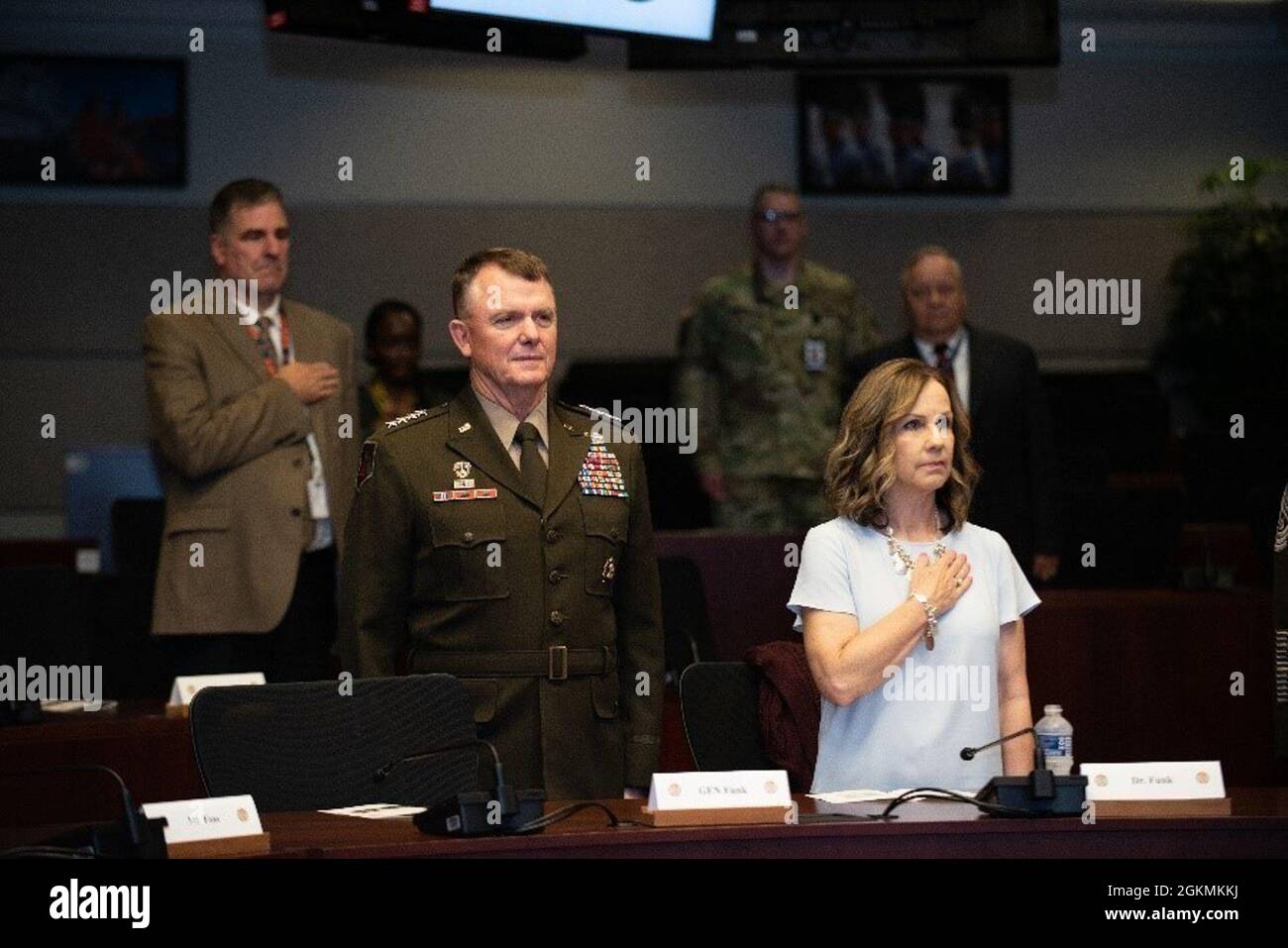 Gen. Paul E. Funk ll and Dr. Elizabeth Funk stand for the playing of ...