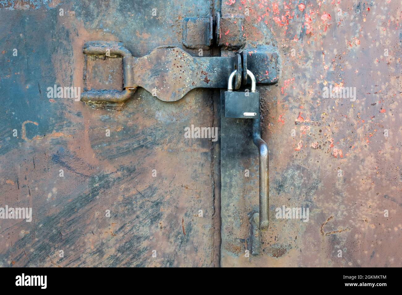 Closed old rusty metal door with lock Stock Photo - Alamy