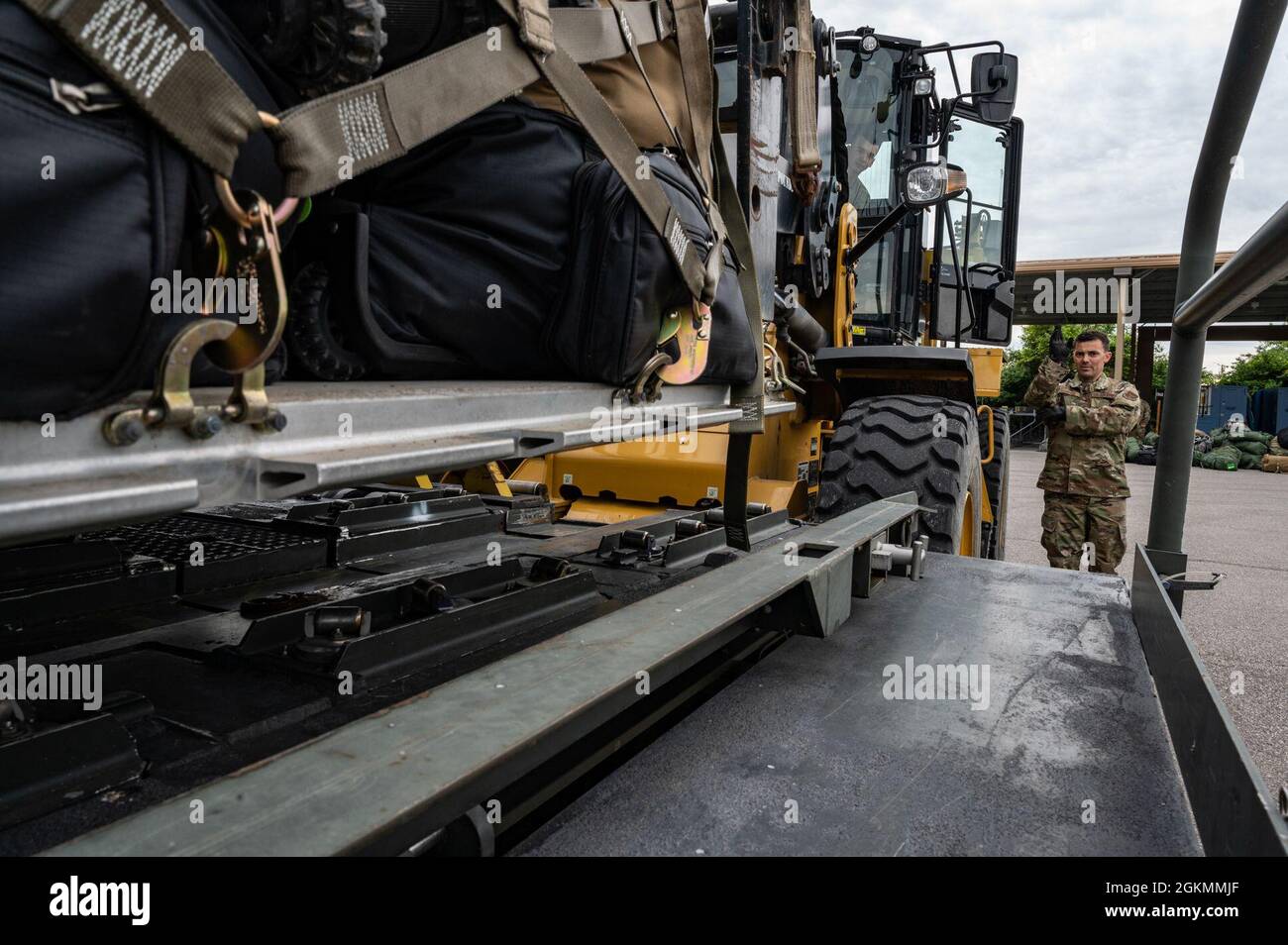Airmen assigned to the 32nd Aerial Port Squadron load a pallet of cargo ...