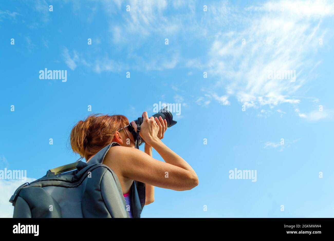 Back view of a woman taking a photo in sunny hi-res stock photography ...