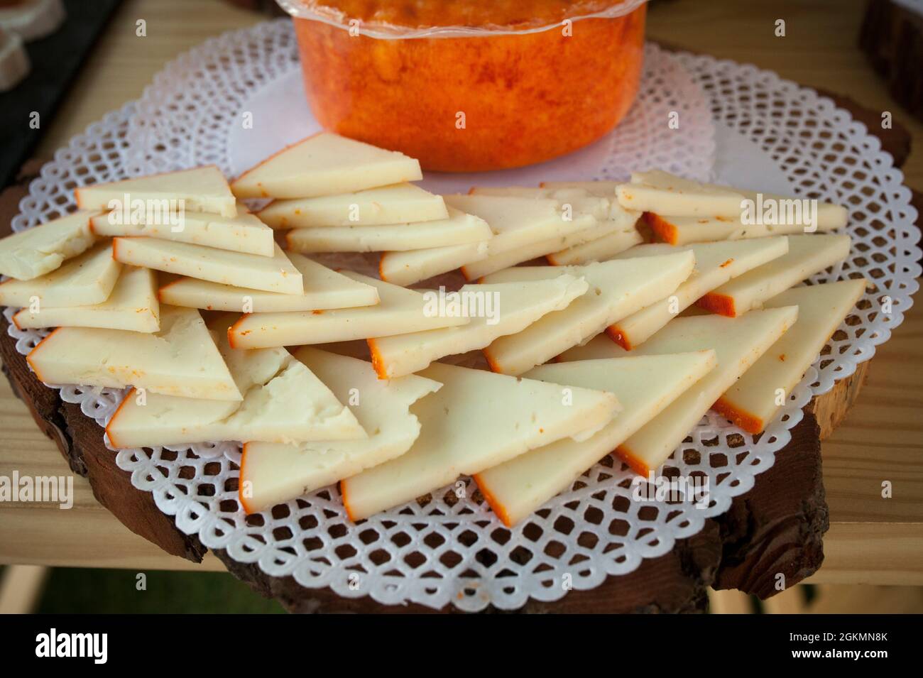 Half-cured smoked paprika cheese slices arrangement. Closeup Stock ...