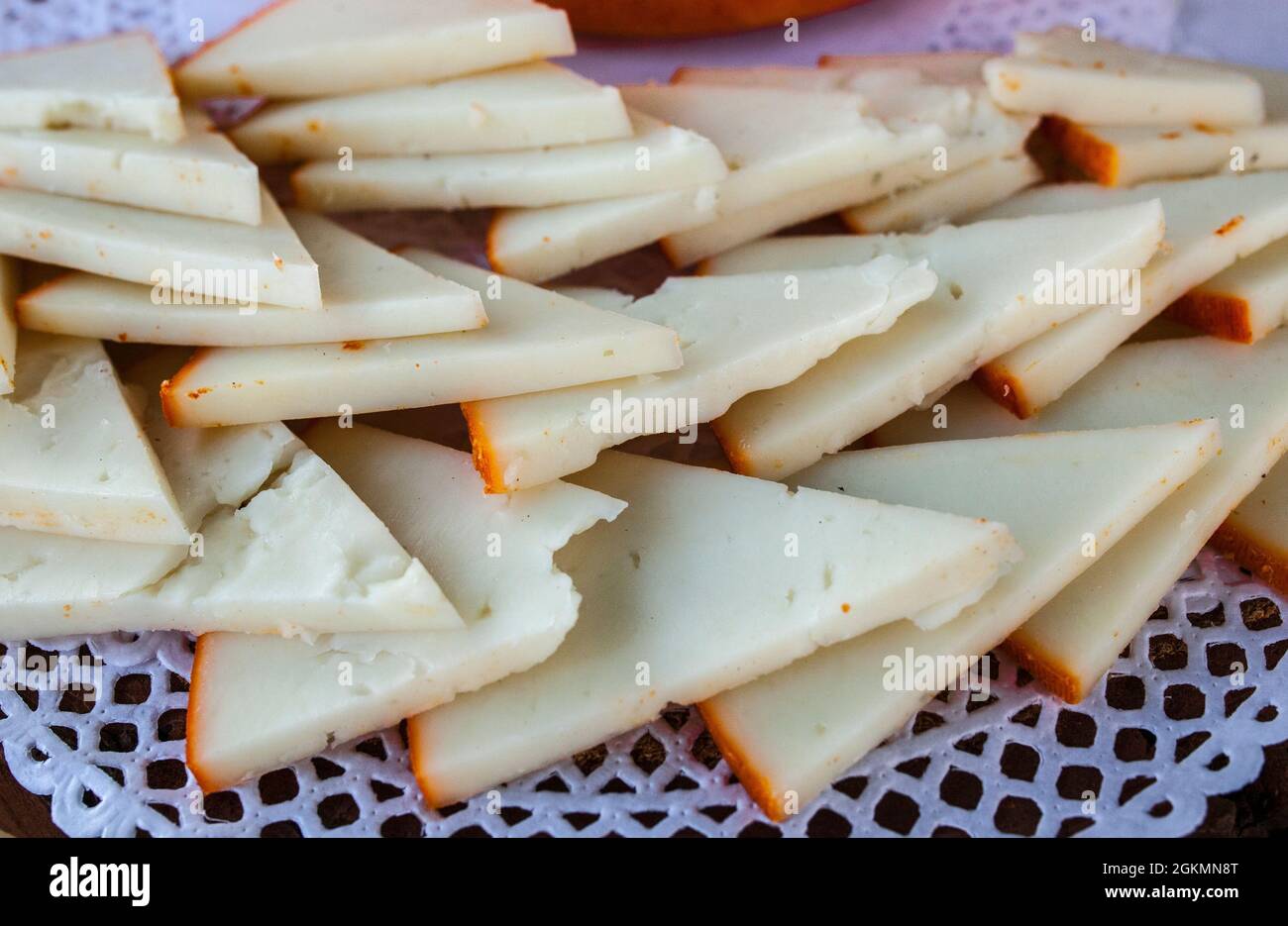 Half-cured smoked paprika cheese slices arrangement. Closeup Stock ...