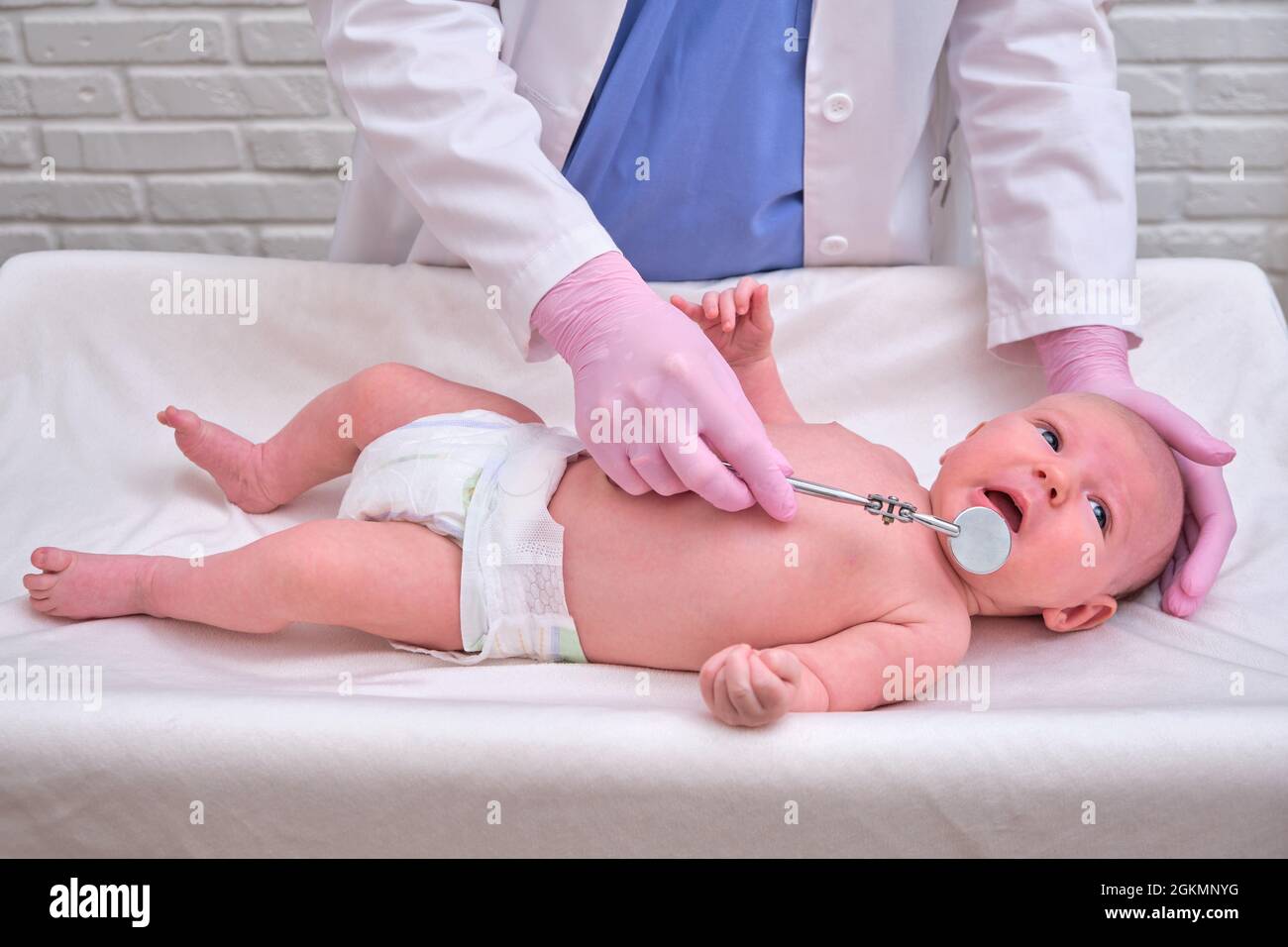 A doctor in uniform checks a child mouth with a mirror. Dentist ...