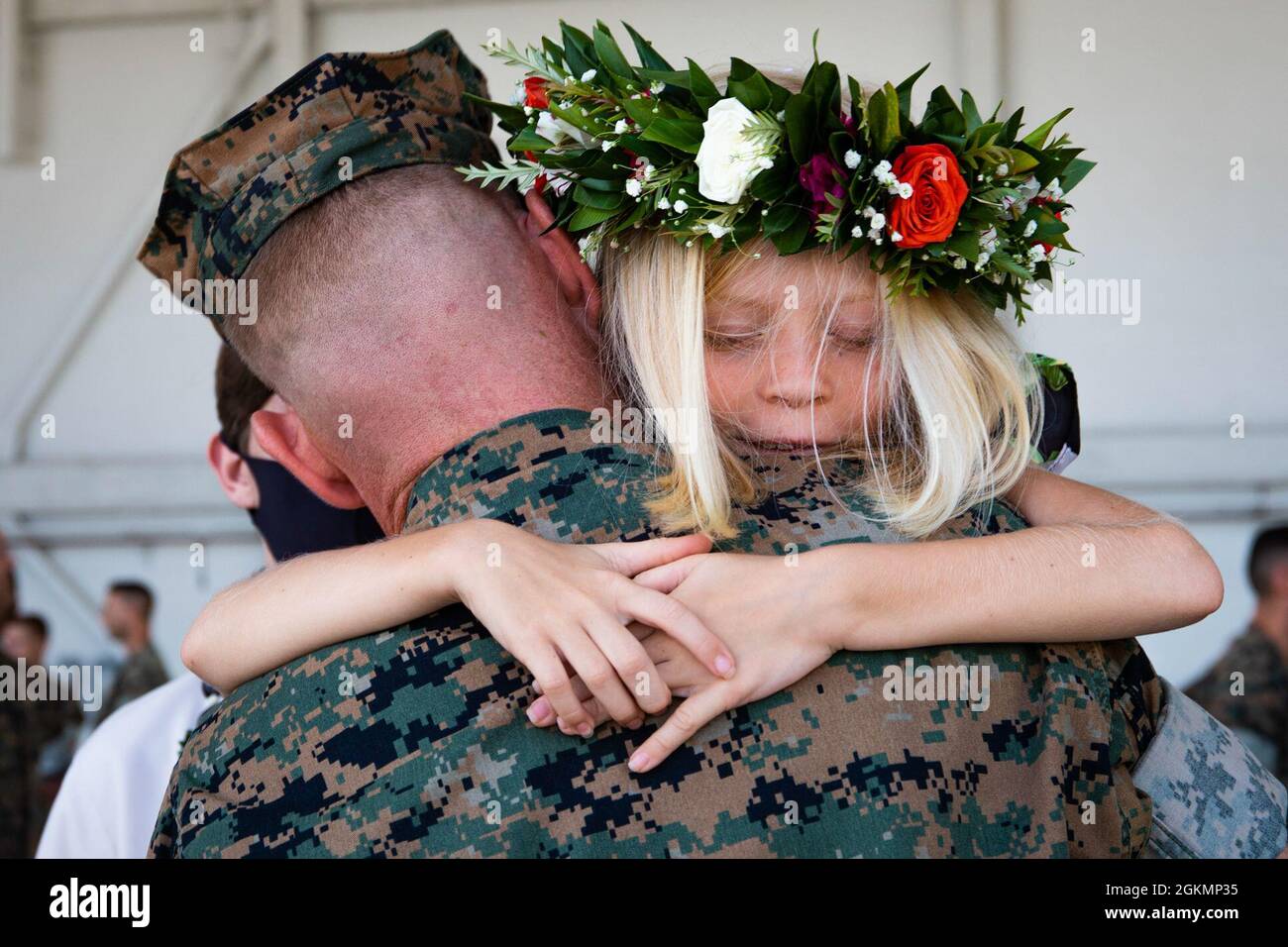 U.S. Marine Corps Lt. Col. Jaret R. Rhinehart embraces his daughter ...