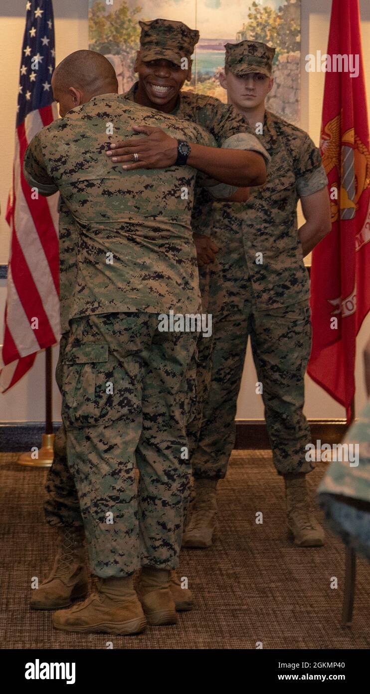 U.S. Marine Corps Master Sgt. Keith Dempsey (ret.) is congratulated by ...