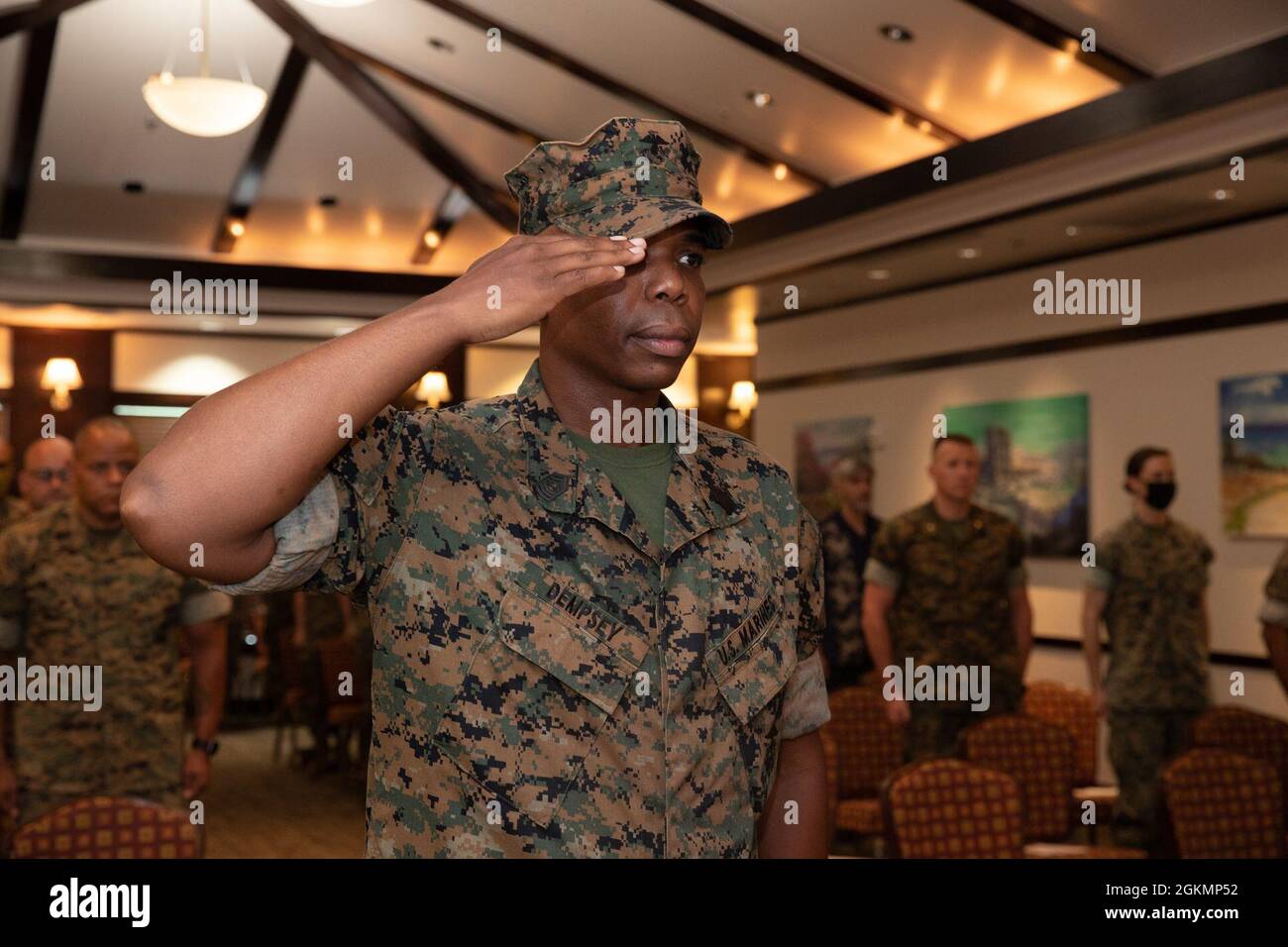 U.S. Marine Corps Master Sgt. Keith Dempsey (ret.) salutes the flag in ...