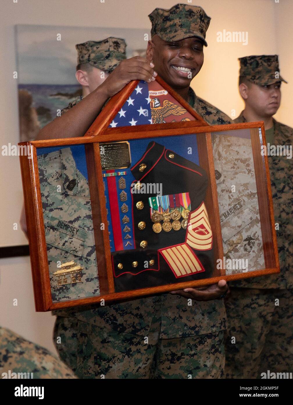 U.S. Marine Corps Master Sgt. Keith Dempsey (ret.) holds a gift given ...