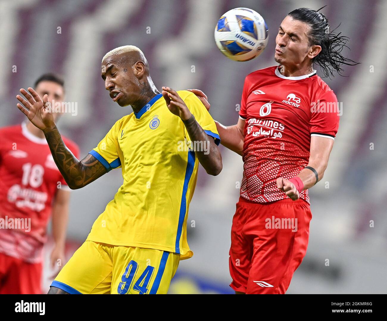 Doha, Qatar. 14th Sep, 2021. Anderson Talisca (L) of Al Nassr vies with ...