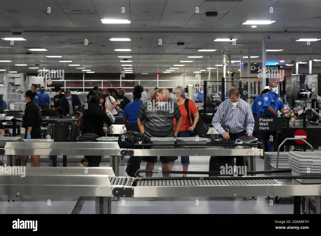 Passengers pass though a TSA security checkpoint at the McCarran ...