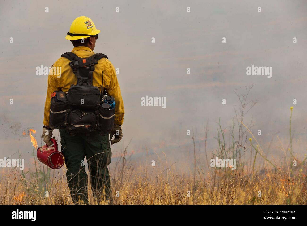 A firefighter with the Camp Pendleton Fire Department ignites brush ...